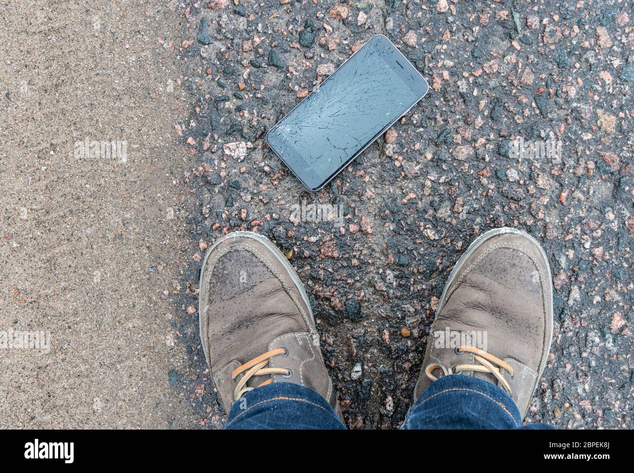 Phone with broken screen on asphalt. Someone dropped device Stock Photo ...