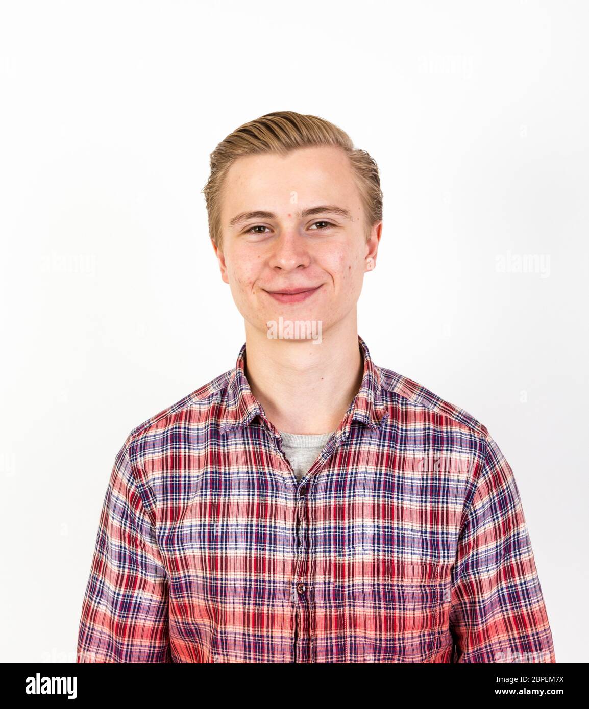 Portrait of a positive boy looking at camera. Isolated over white Stock ...