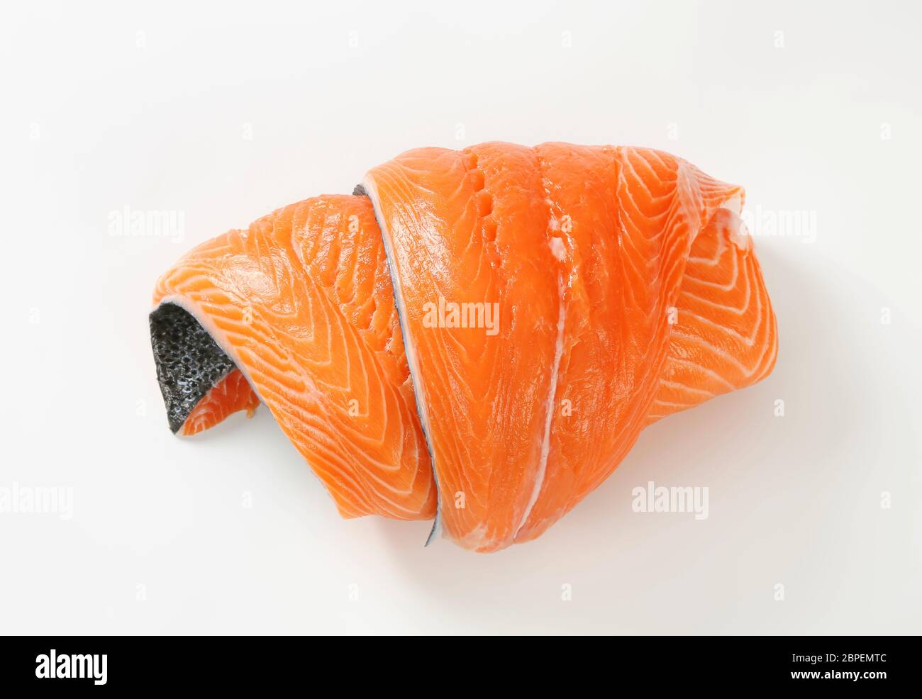 roll of raw salmon fillet on white background Stock Photo - Alamy
