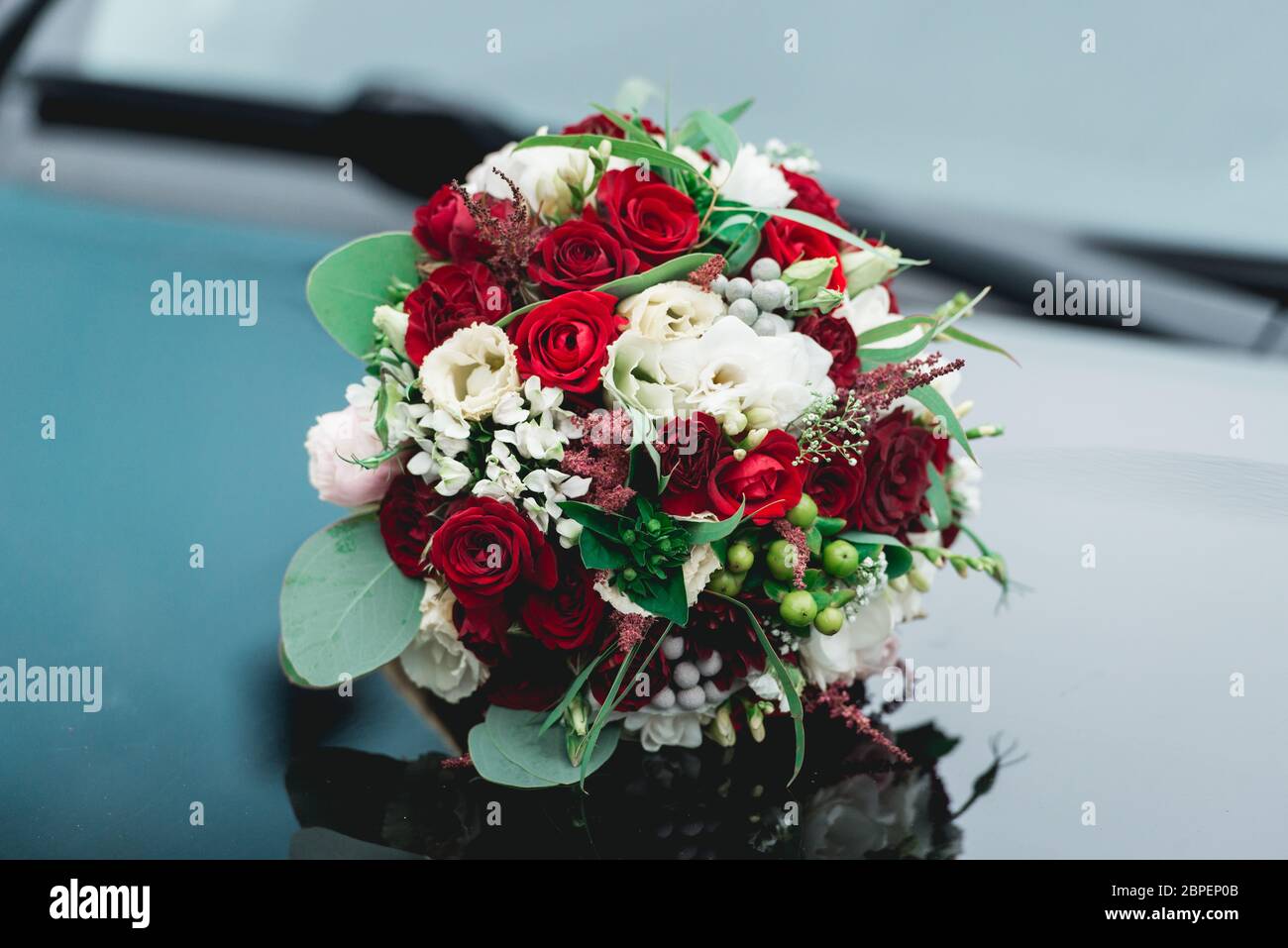 wedding bouquet of white and red roses on a car hood Stock Photo - Alamy