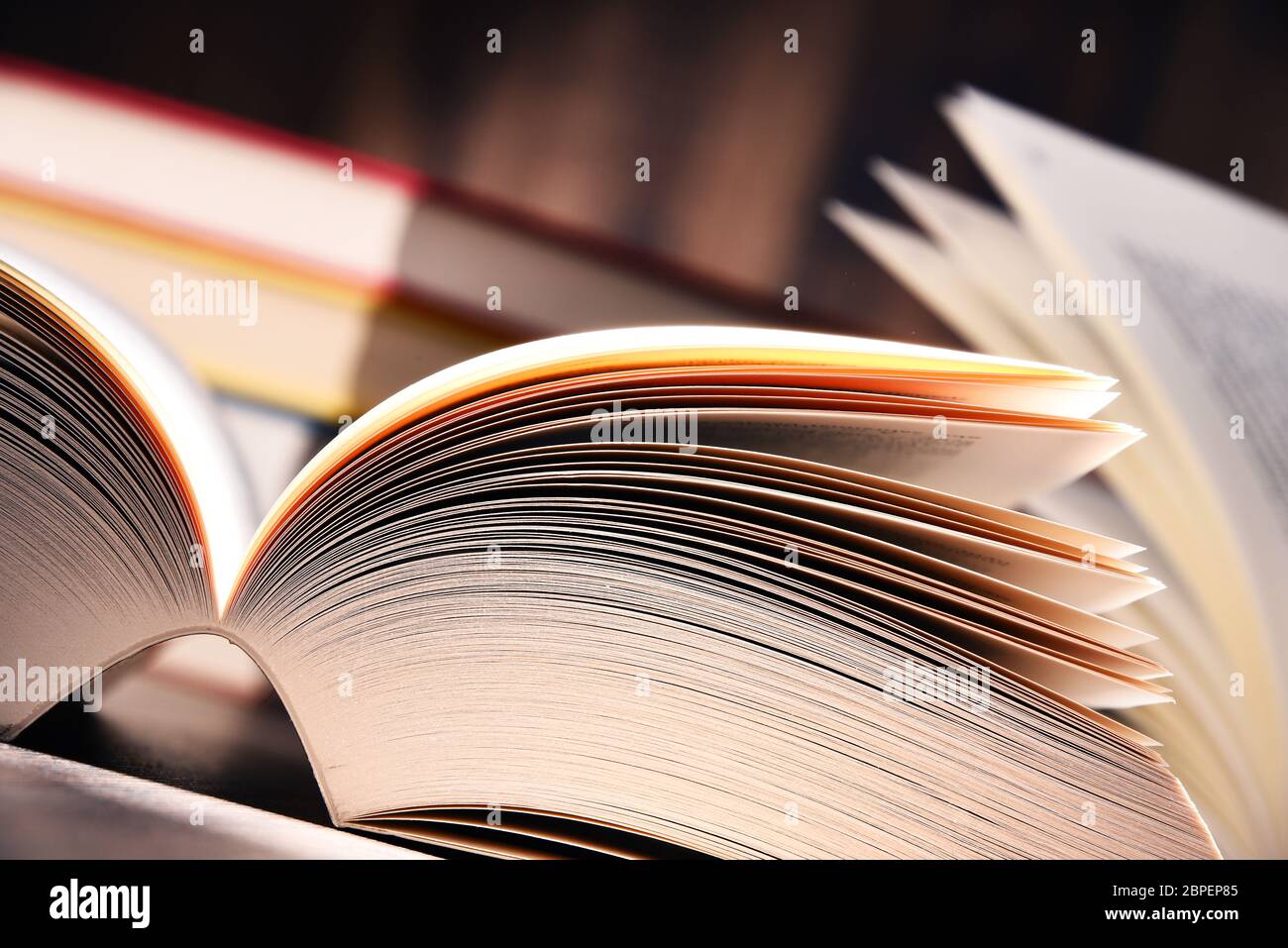 Composition with open book on the table Stock Photo - Alamy