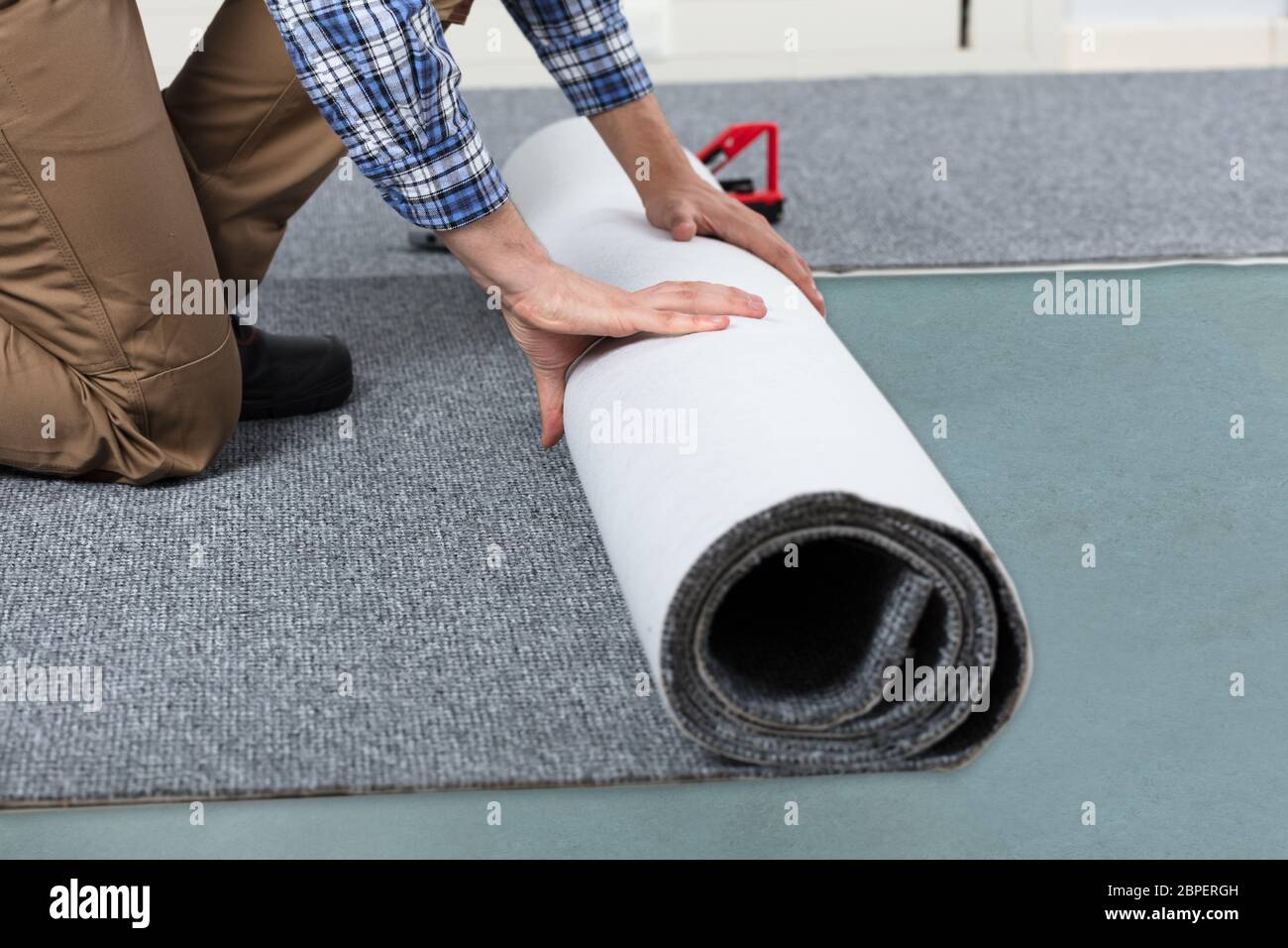 Man unrolling carpet hi-res stock photography and images - Alamy