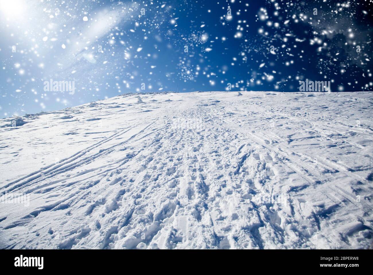 Snow covered hillside in the high mountains in bright sunshine Stock ...