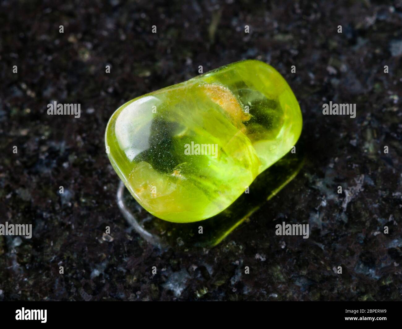 macro shooting of natural mineral rock specimen - polished Peridot gem ...