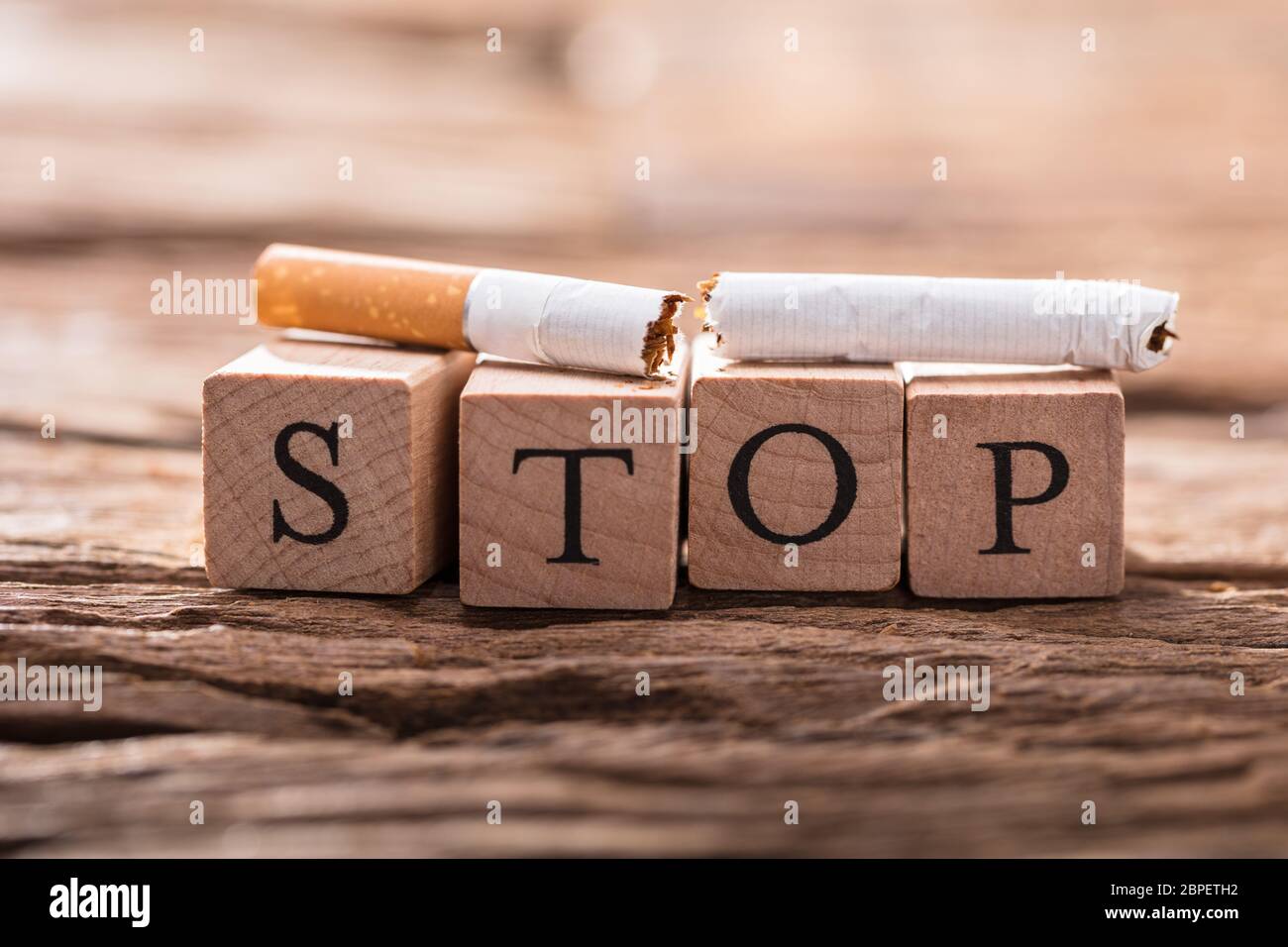Close-up Of A Cigarette And Wooden Blocks Showing Stop Word On Desk ...
