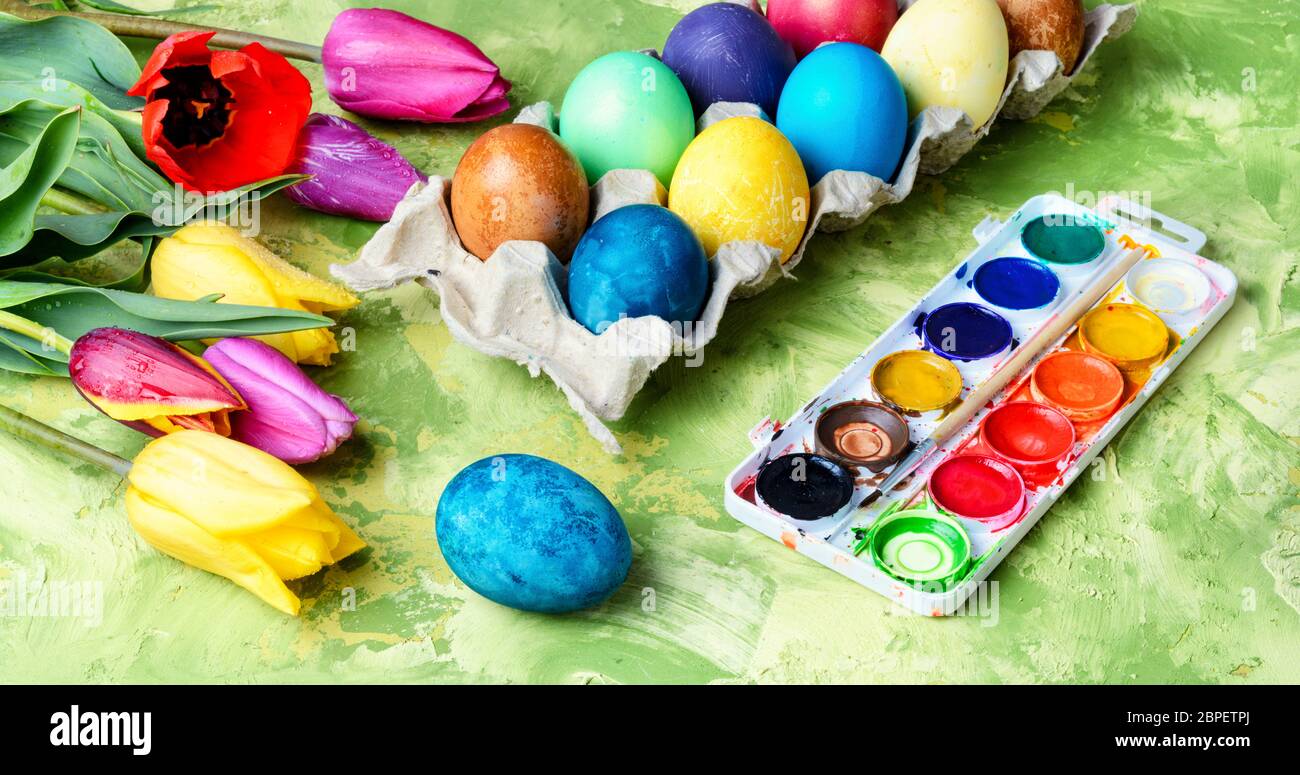 symbolic Easter colored egg and colorful paint Stock Photo - Alamy