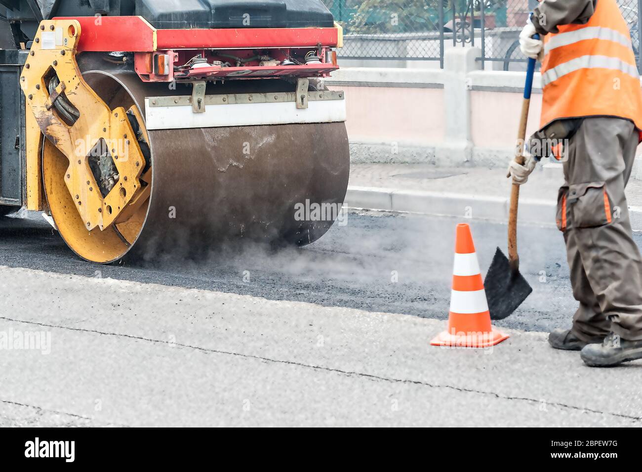 Road roller at work. Work of asphalting a road Stock Photo - Alamy