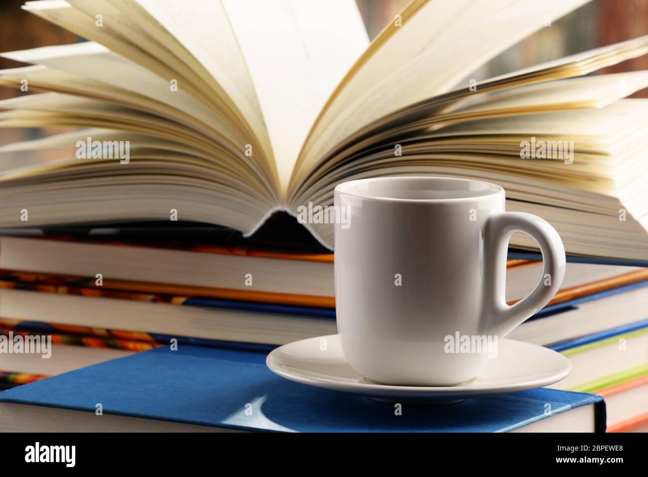 Composition with books and cup of coffee Stock Photo - Alamy