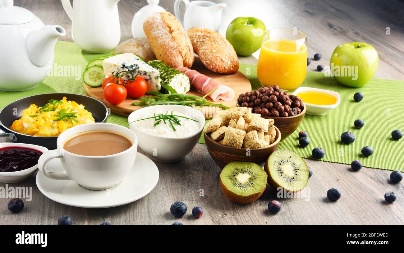 Breakfast served with coffee, orange juice, cheese, cereals and ...