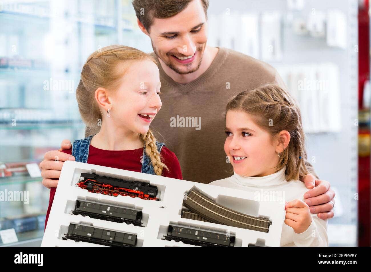Father and children in toy store hi-res stock photography and images ...