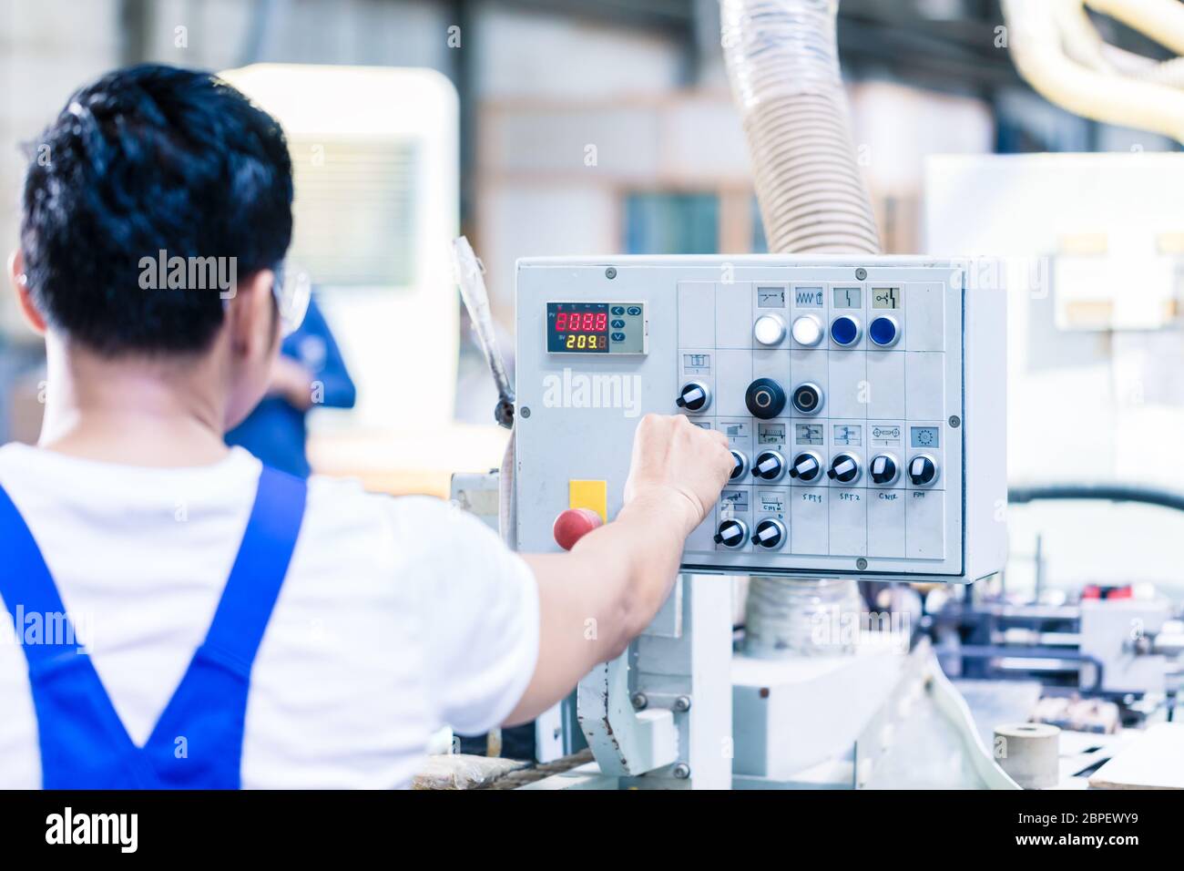 Man pressing buttons on machine hi-res stock photography and images - Alamy