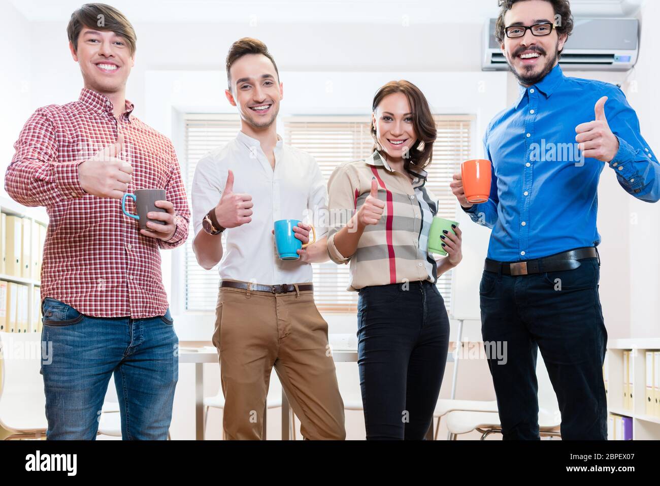 Young creative entrepreneurs being motivated, one woman and three men ...