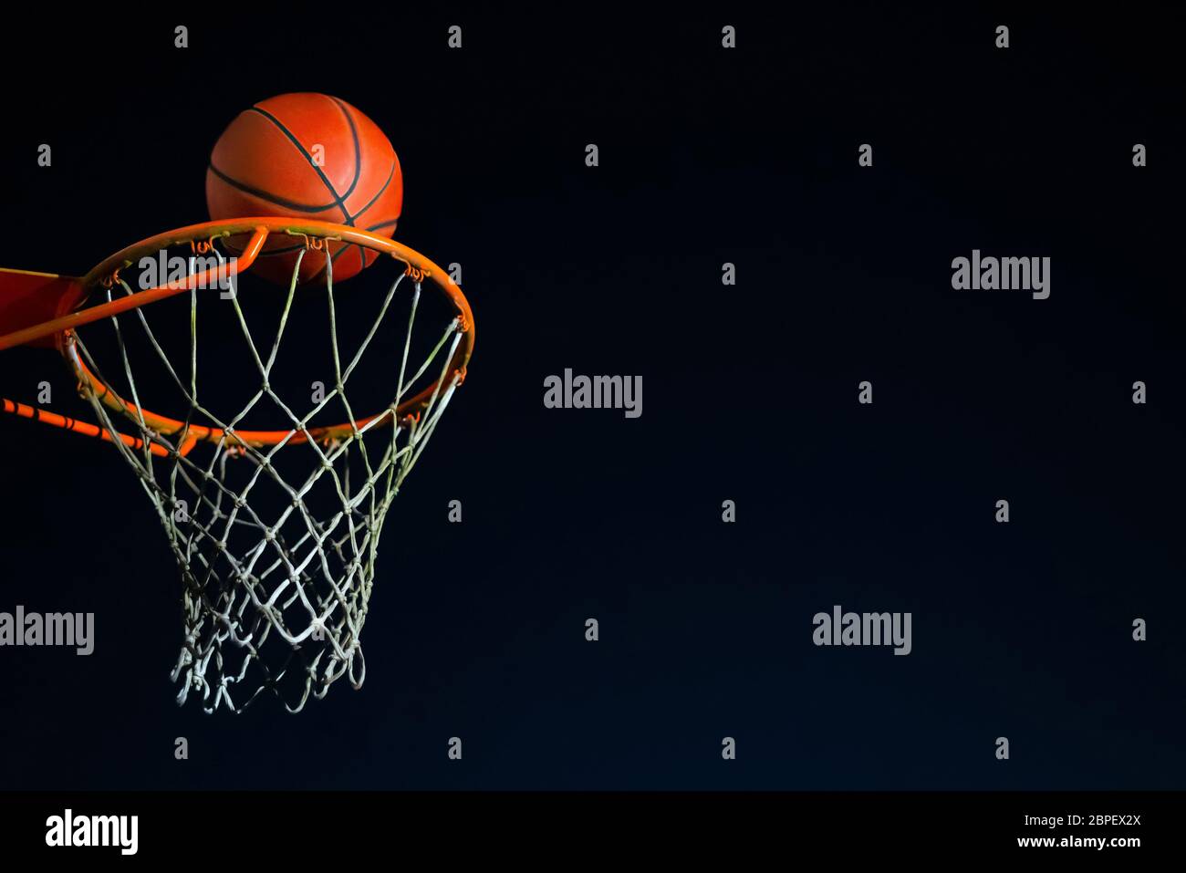 Street basketball ball falling into the hoop at night. Urban youth game ...