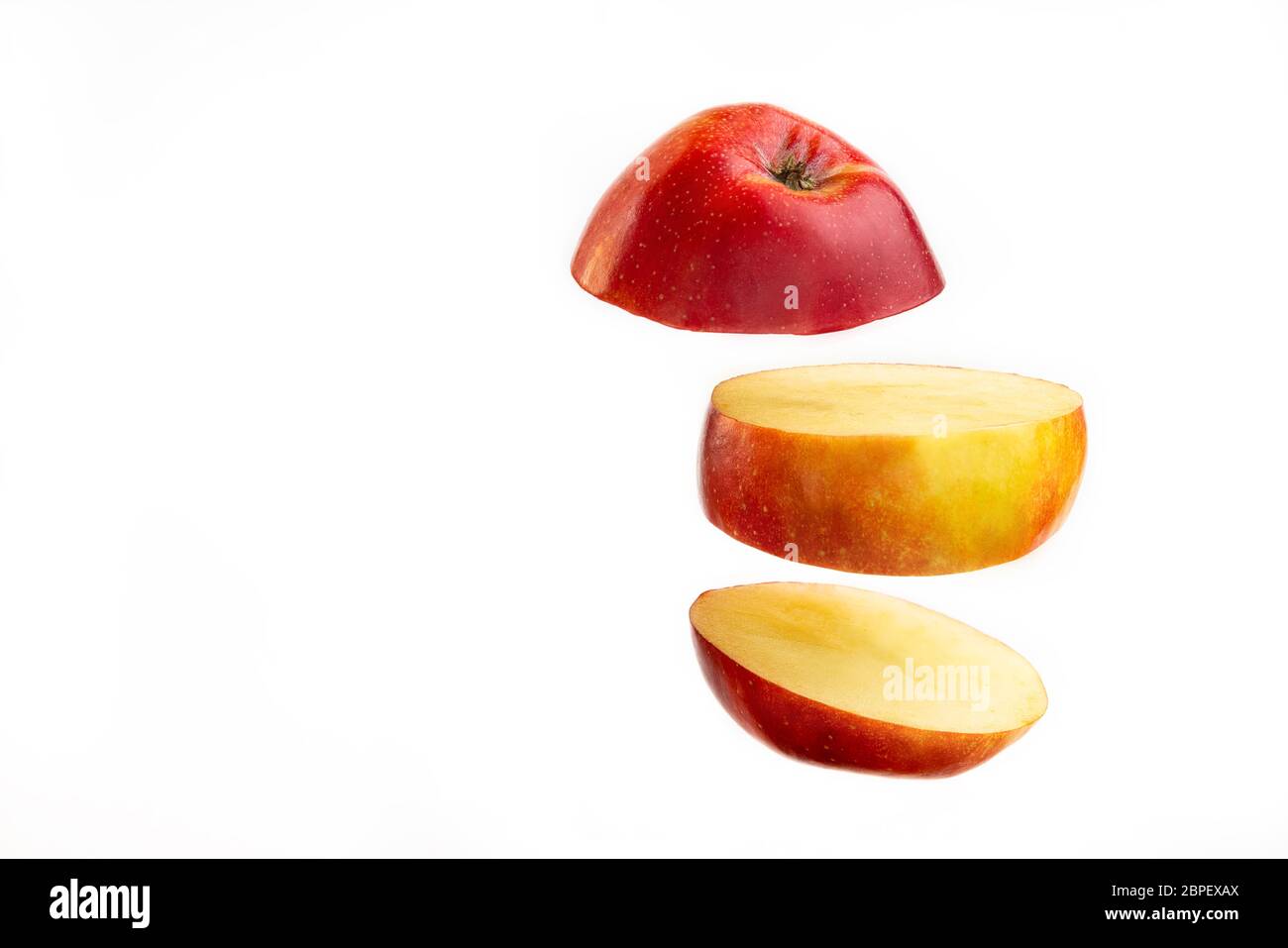 Sliced apple floating on white background. Fruit slice falling on ...