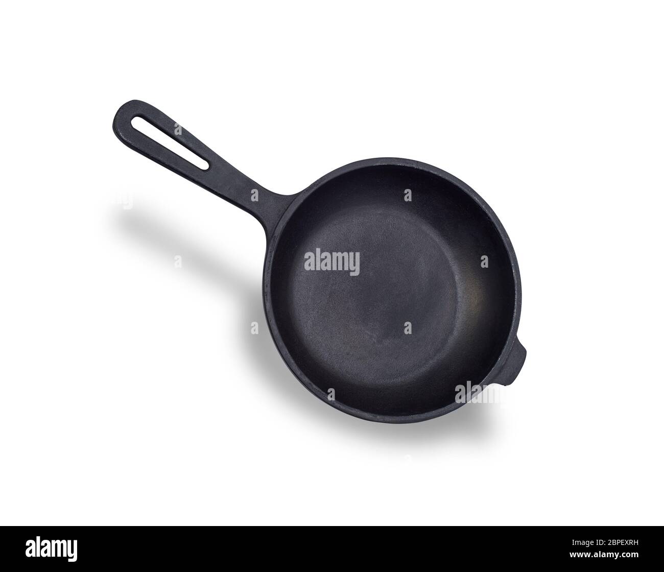 round black cast-iron frying pan with handle isolated on white ...