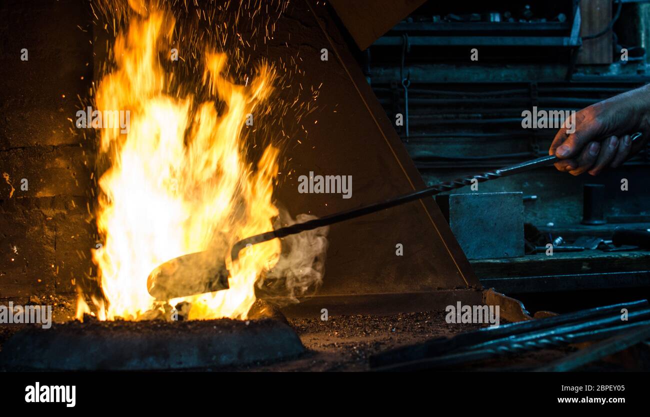 Blacksmith at work, hit with a hammer by a hot metal on the anvil Stock ...