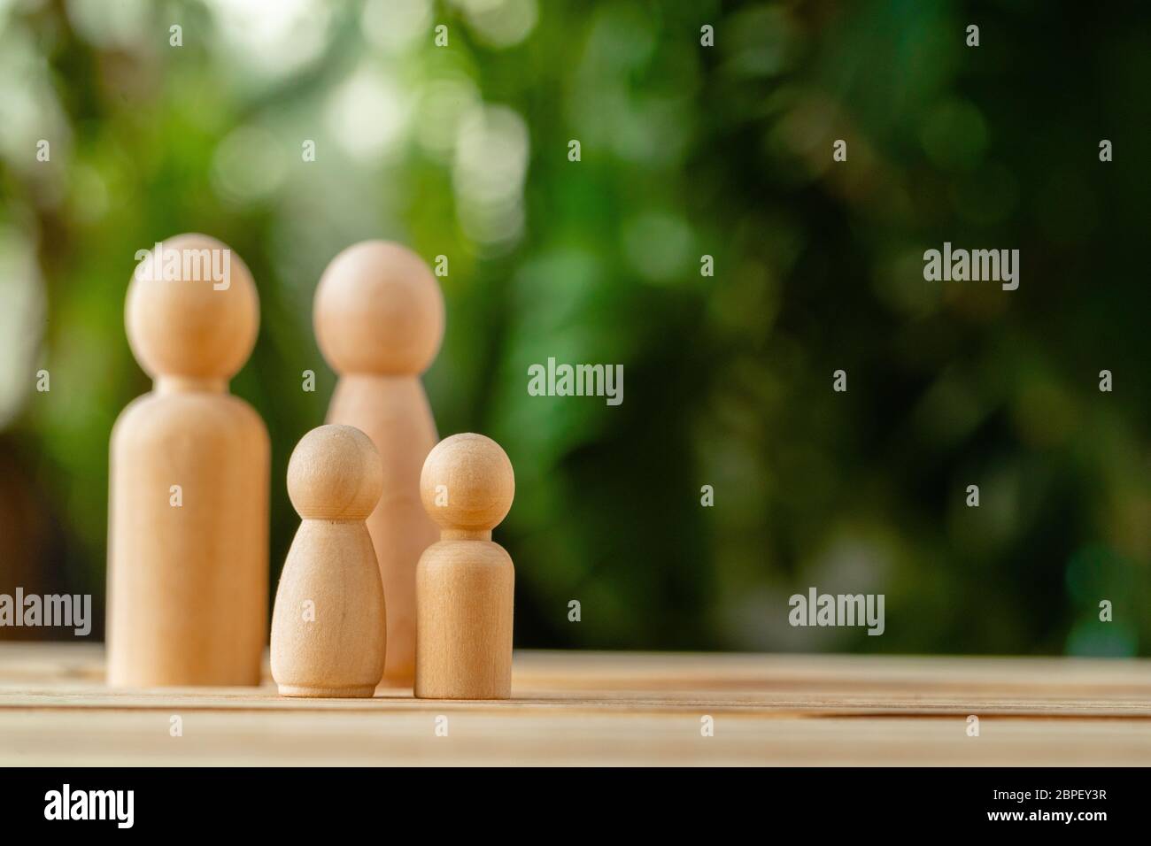 Wooden little figures of people. Family concept Stock Photo - Alamy