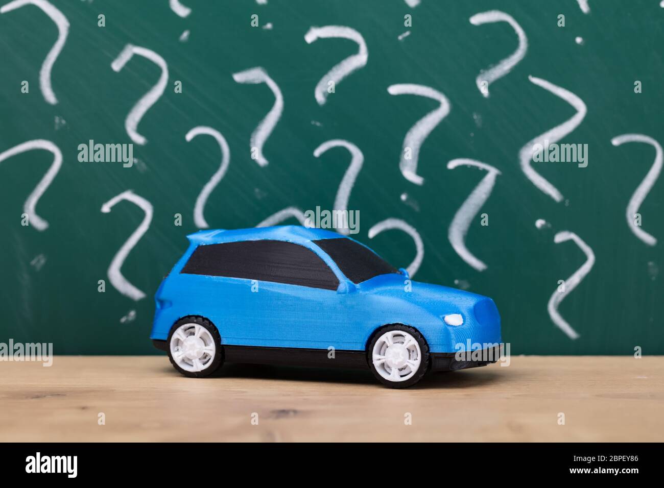Close-up Of A Blue Car In Front Of Chalkboard Showing Question Mark ...