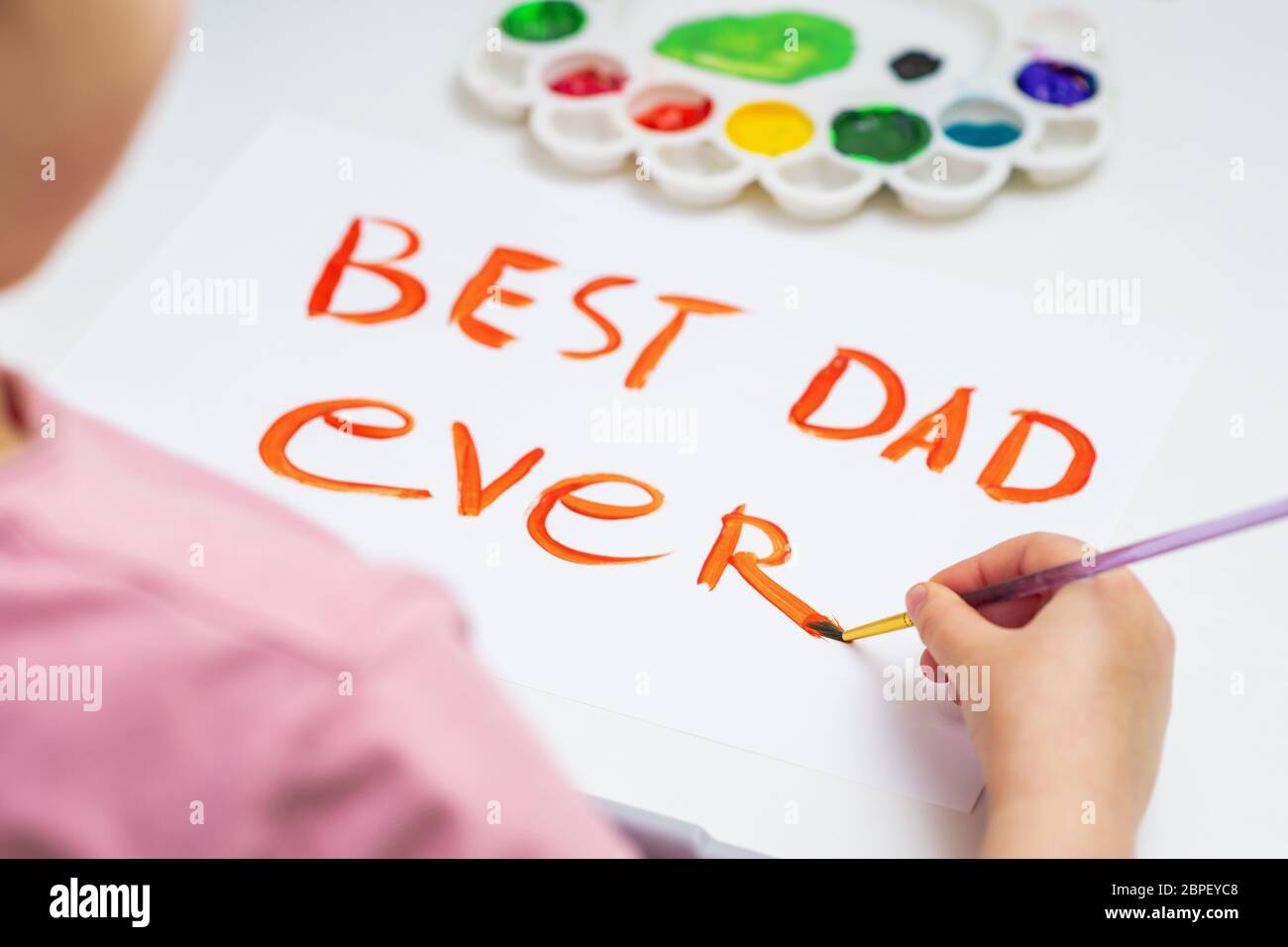 Child is drawing handwritten text Best Dad Ever on white paper. Happy ...