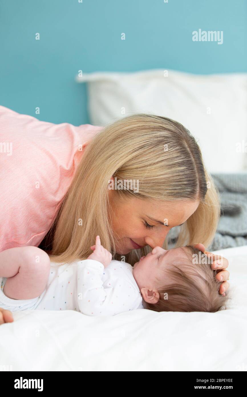 Cuddling newborn baby in bed hi-res stock photography and images - Alamy