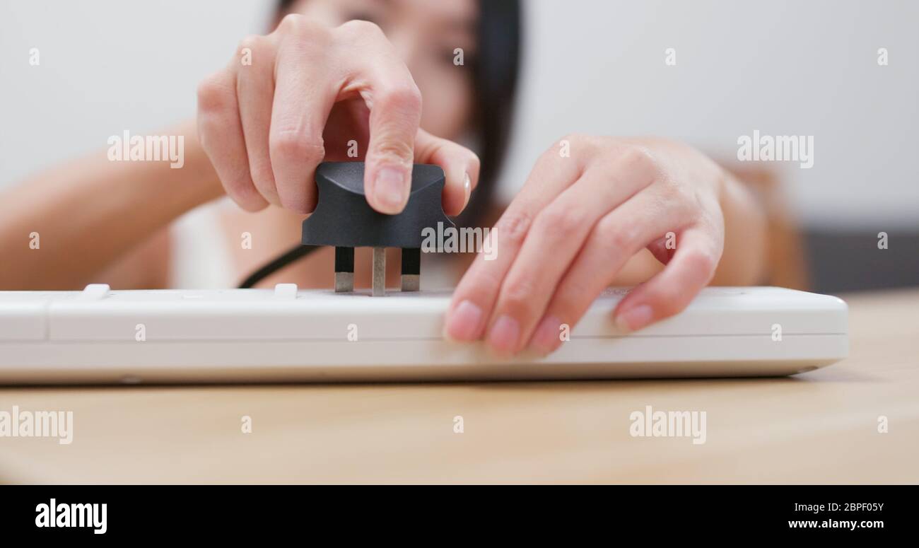 Plug in the power cord on power socket Stock Photo - Alamy
