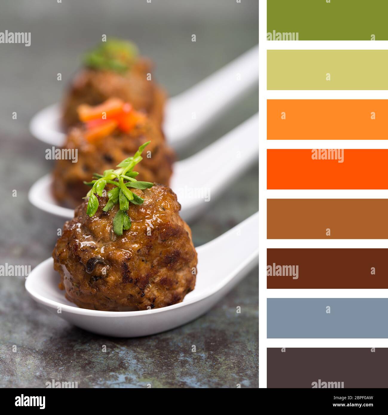 A trio of Asian meatballs in white ceramic spoons, garnished with ...