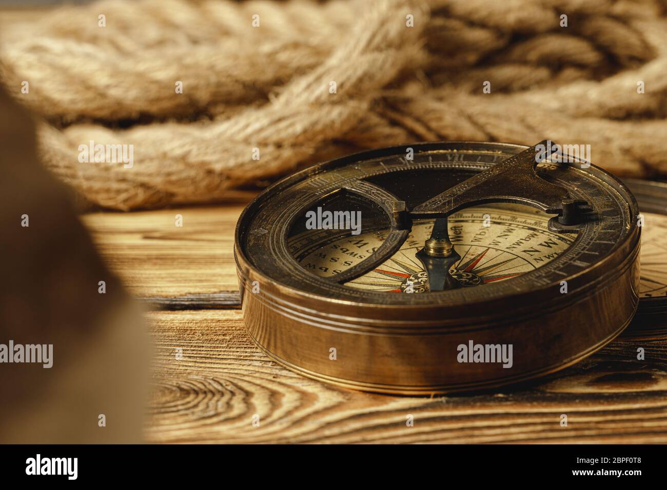 Ship rope and compass on wooden background Stock Photo - Alamy