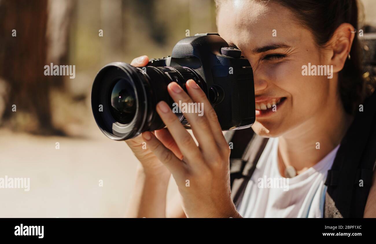 Closeup of a female taking photographs of the landscape with a digital ...
