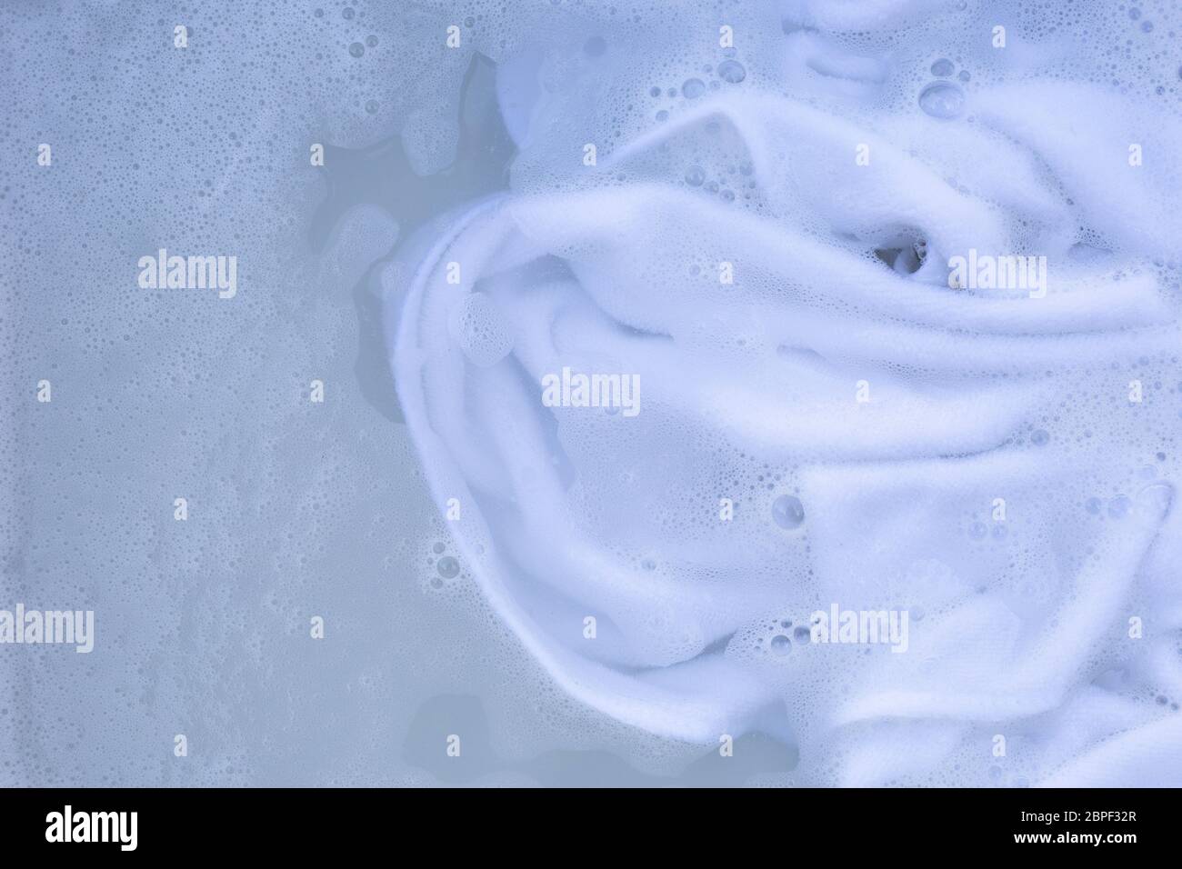 Soak a cloth before washing, white cloth Stock Photo - Alamy