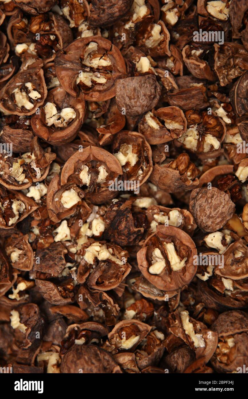 Closeup at the heap of cracked wallnuts Stock Photo - Alamy