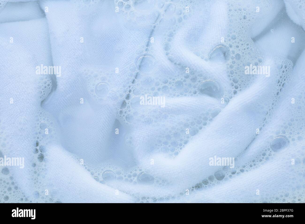 Soak a cloth before washing, white cloth Stock Photo - Alamy