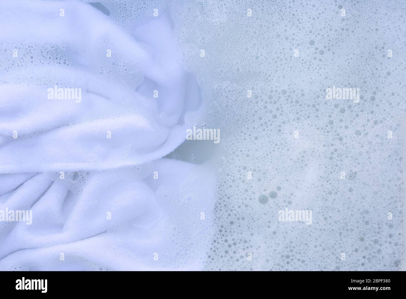 Soak a cloth before washing, white cloth Stock Photo - Alamy