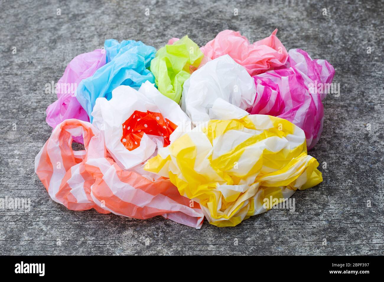 Plastic bags waste on cement floor background Stock Photo - Alamy