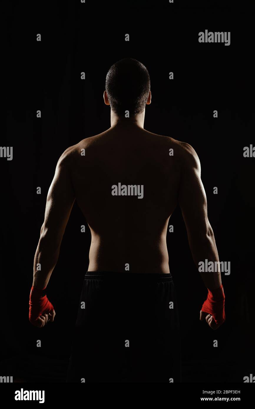 Male boxer posing his powerful back against black background Stock ...