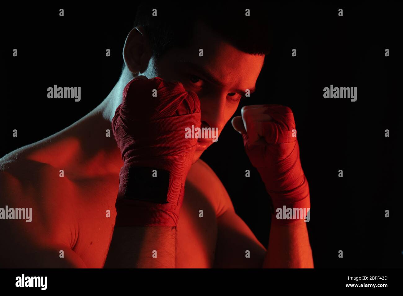 Boxer male fighter posing in confident defensive stance with hands in ...