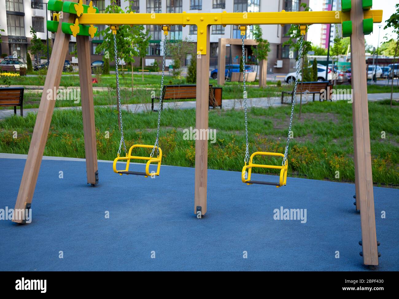 Empty chain swing in playground. Children park with yellow swings Stock ...