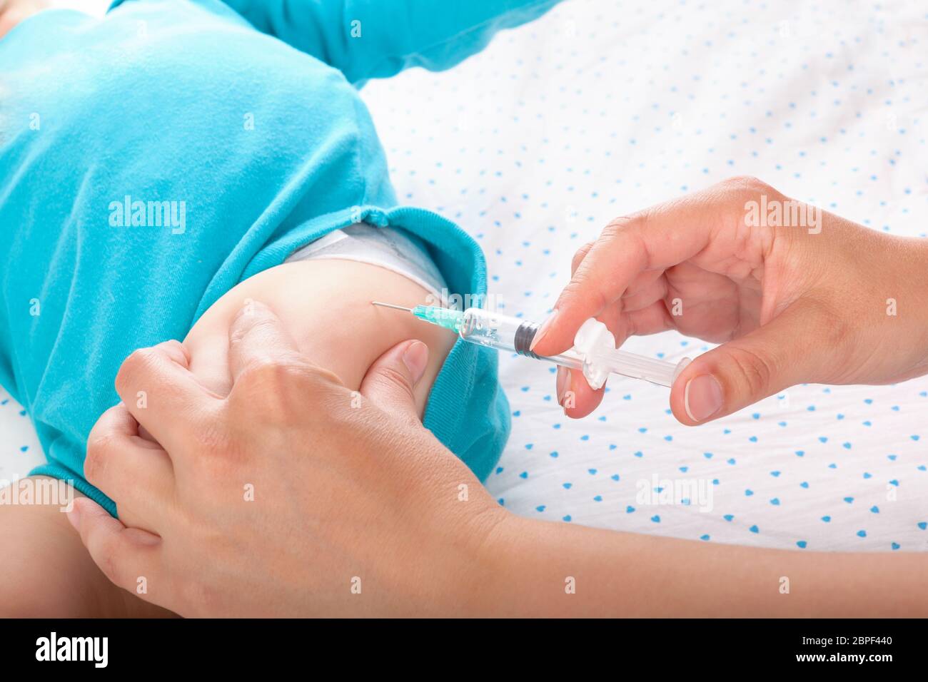 Pediatrician giving a baby boy intramuscular injection. Medicine ...