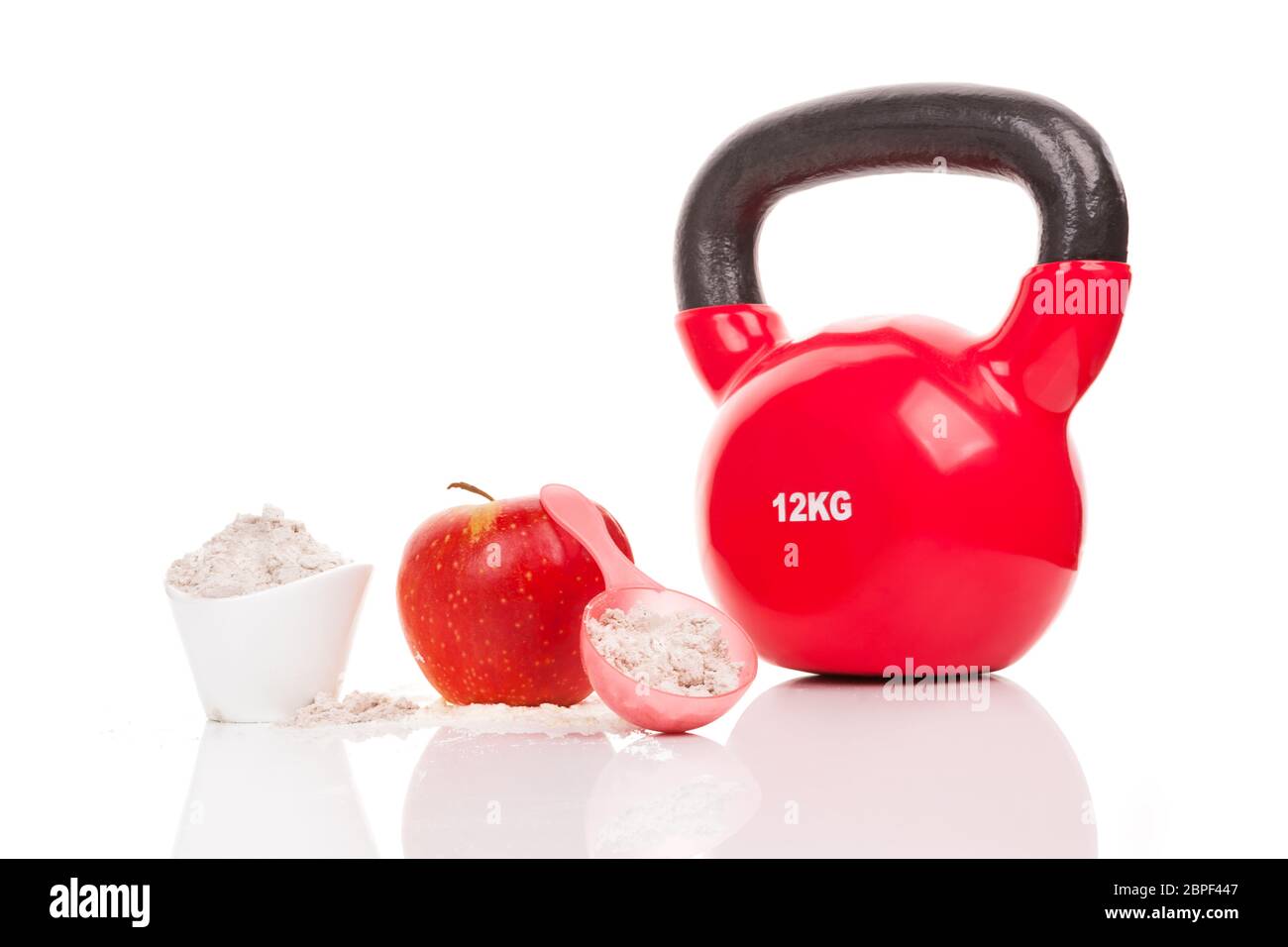 Tasty protein powder with apple and kettlebell isolated on white ...
