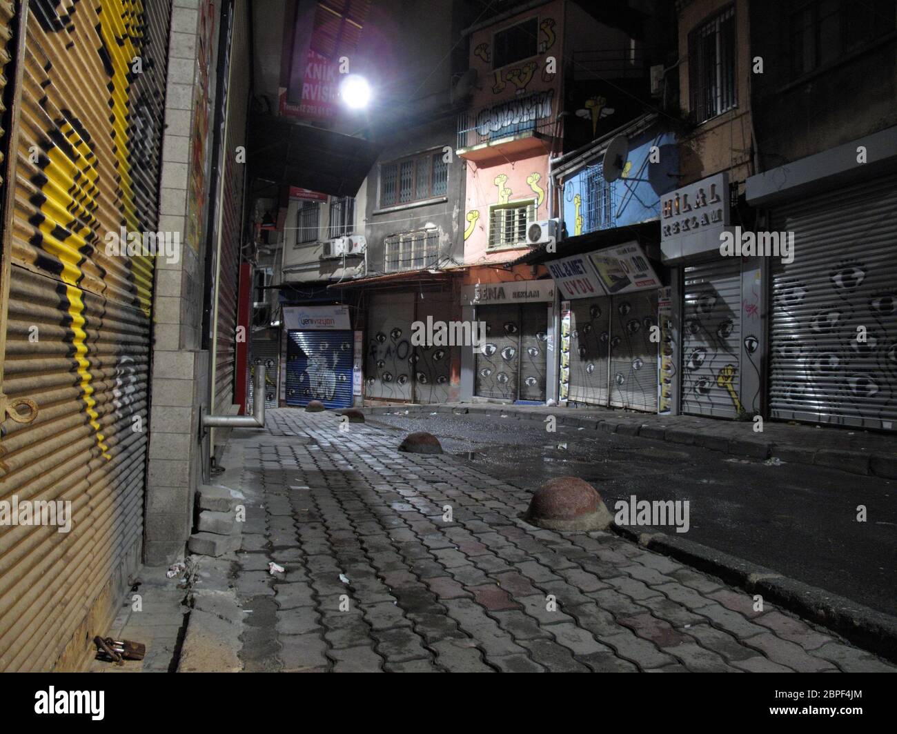 Night view of pedestrian alley with graffiti-covered walls and metal ...
