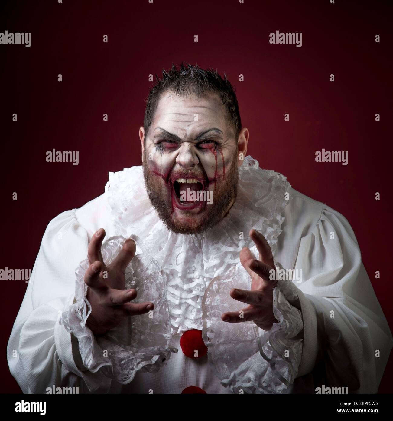 Portrait of a Scary Evil Clown. Studio shot with horrible face art ...