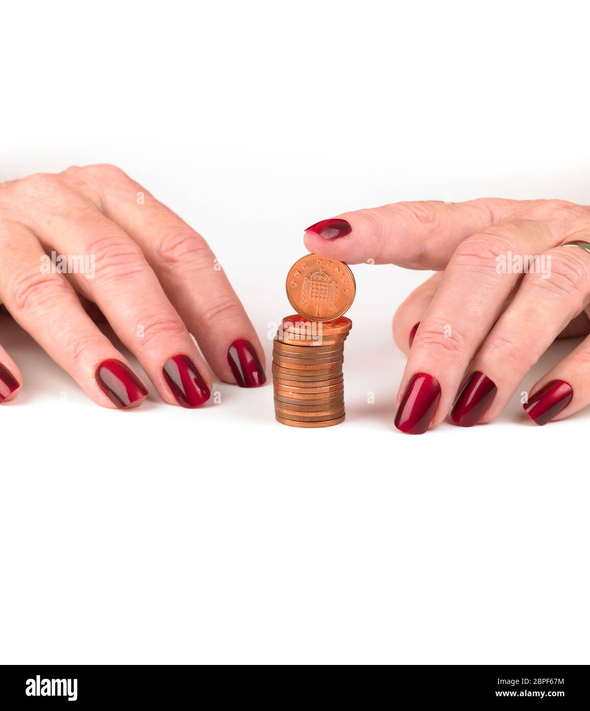 Middle age womans hands with bright red nails counting pile of coins on ...