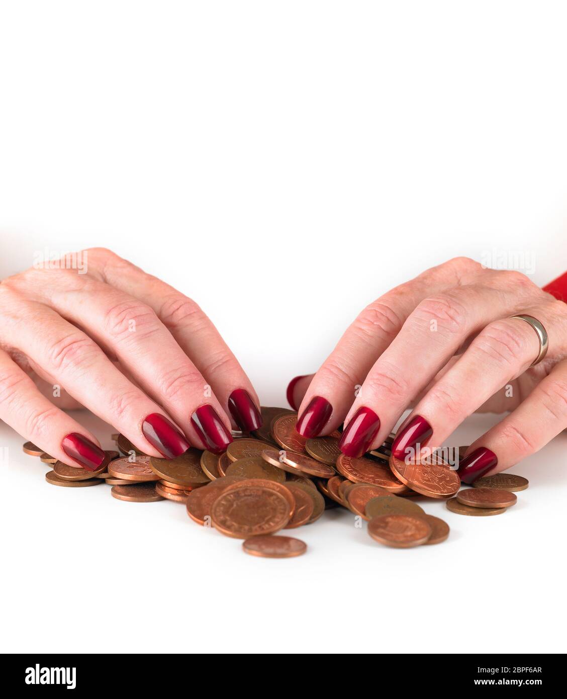 Middle age womans hands with bright red nails counting pile of coins on ...