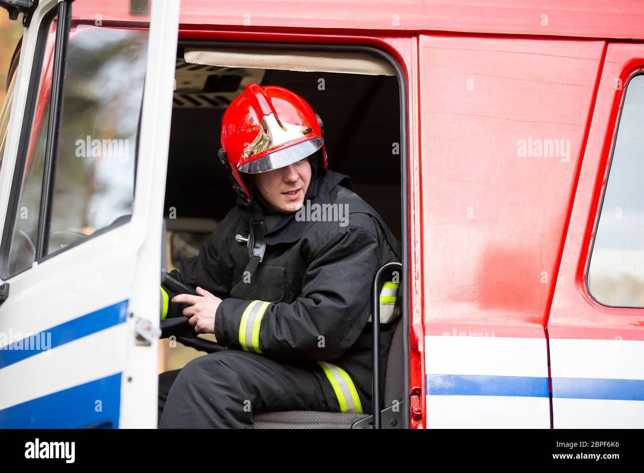 A fireman is sitting in a fire truck Stock Photo - Alamy