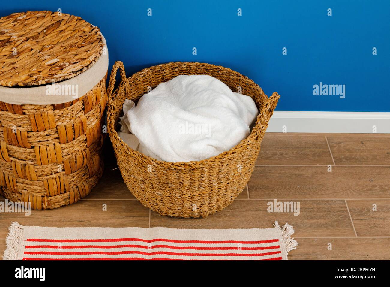 Pile of clothes in laundry basket indoors Stock Photo - Alamy