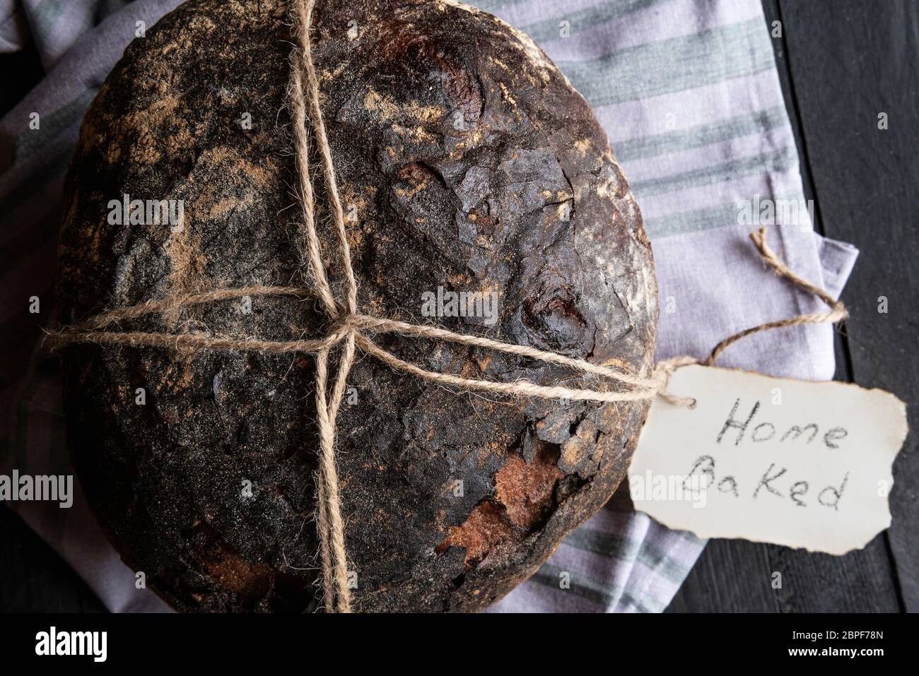 Brown bread with delicious crust tied up with a rope and a paper ...