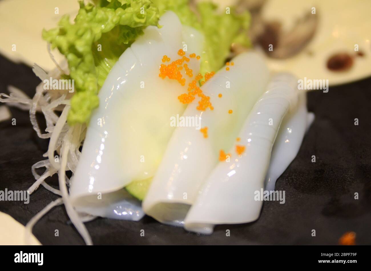 Traditional japanese food Ika (Squid) sashimi on wooden table Stock ...