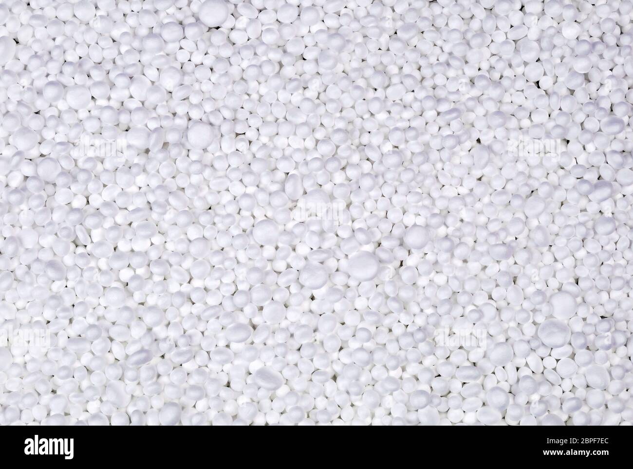 Filler of small white pieces of styrofoam for packaging. For background ...