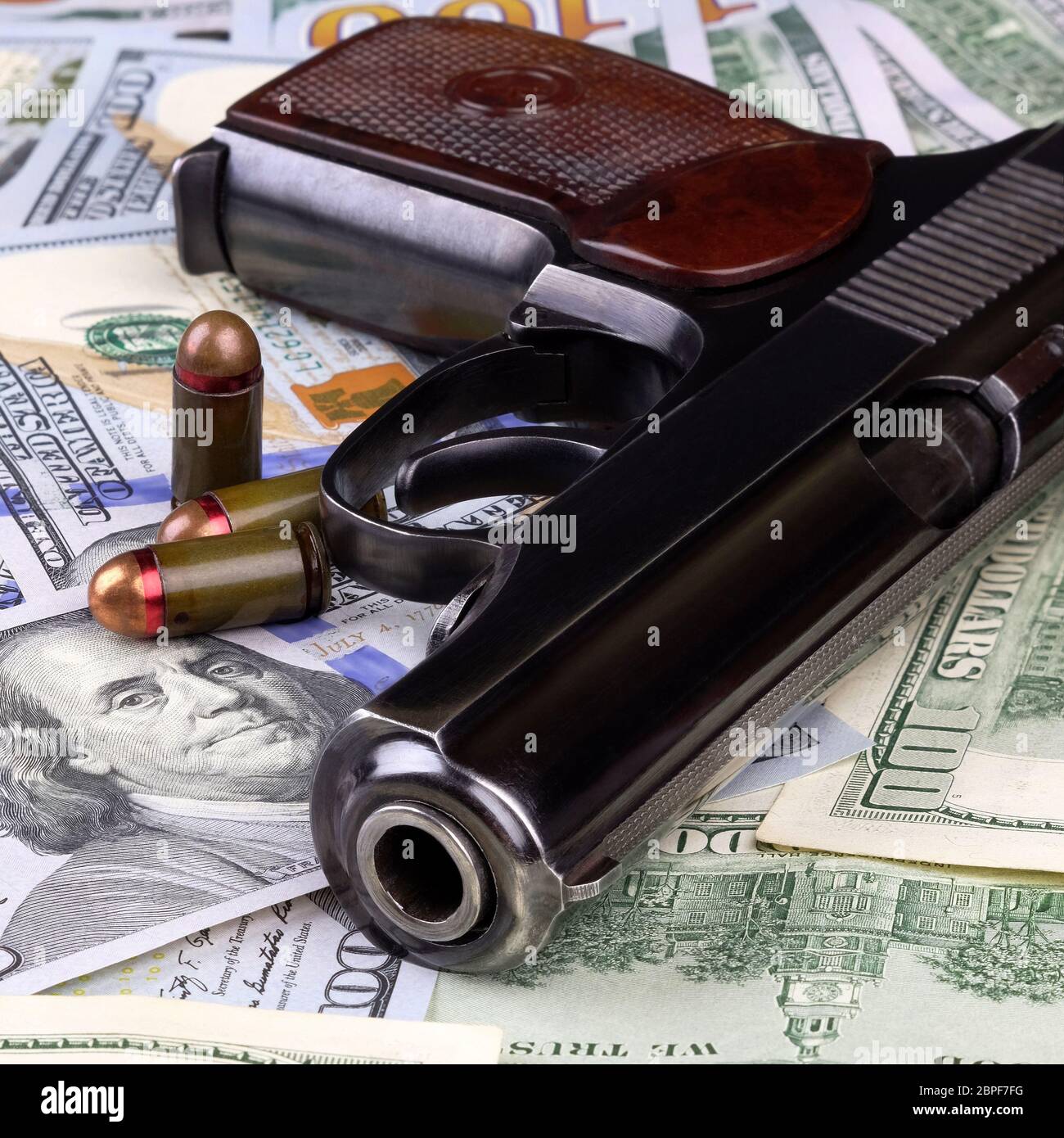 Pistol with bullets on the banknotes of American dollars, crime or ...