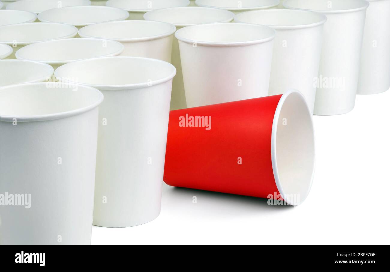 One different unique red paper cup among white ordinary cups lined up ...