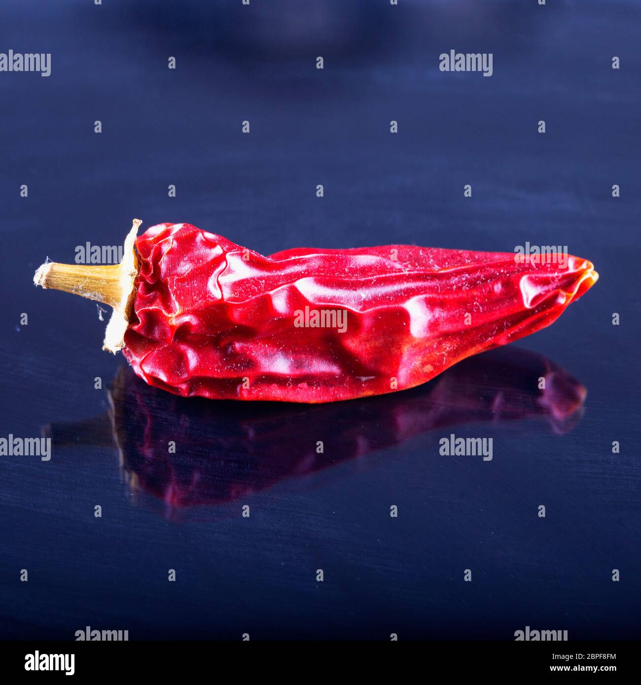 Red hot pepper over black reflecting background, square image Stock ...
